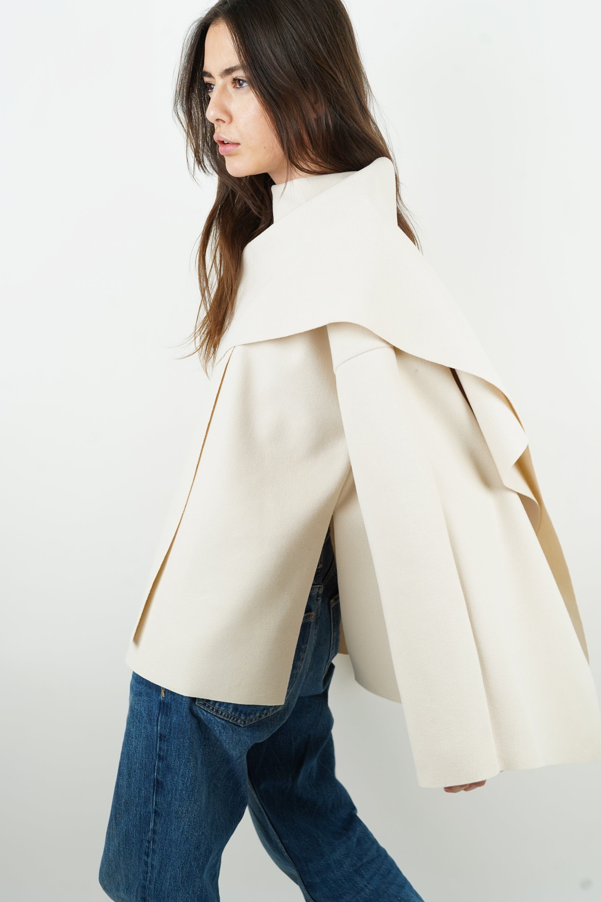 Beige cape open and draped around the shoulders